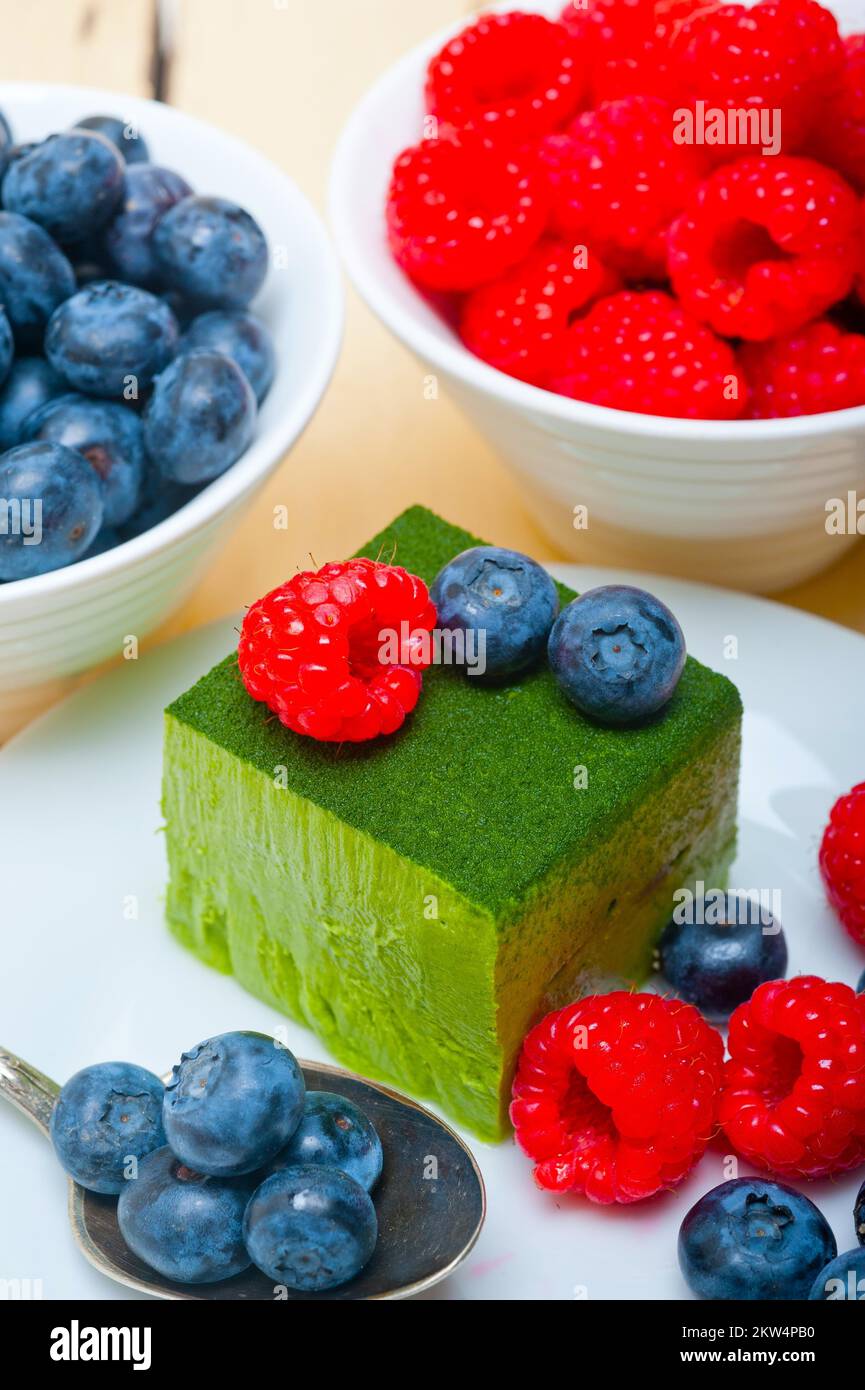 Green tea matcha mousse cake with raspberries and blueberries on top ...