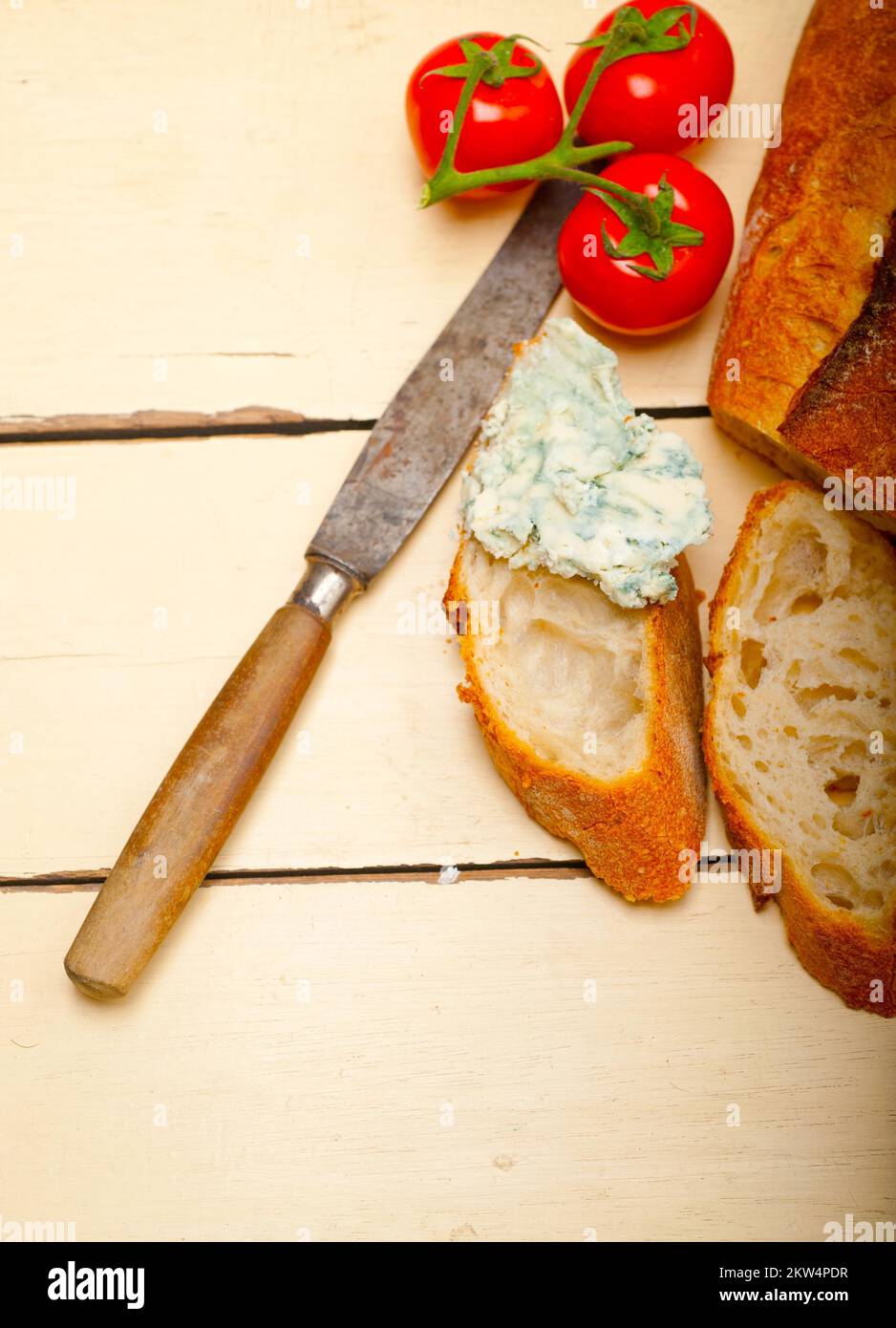 Fresh blue cheese spread ove french baguette with cherry tomatoes on ...