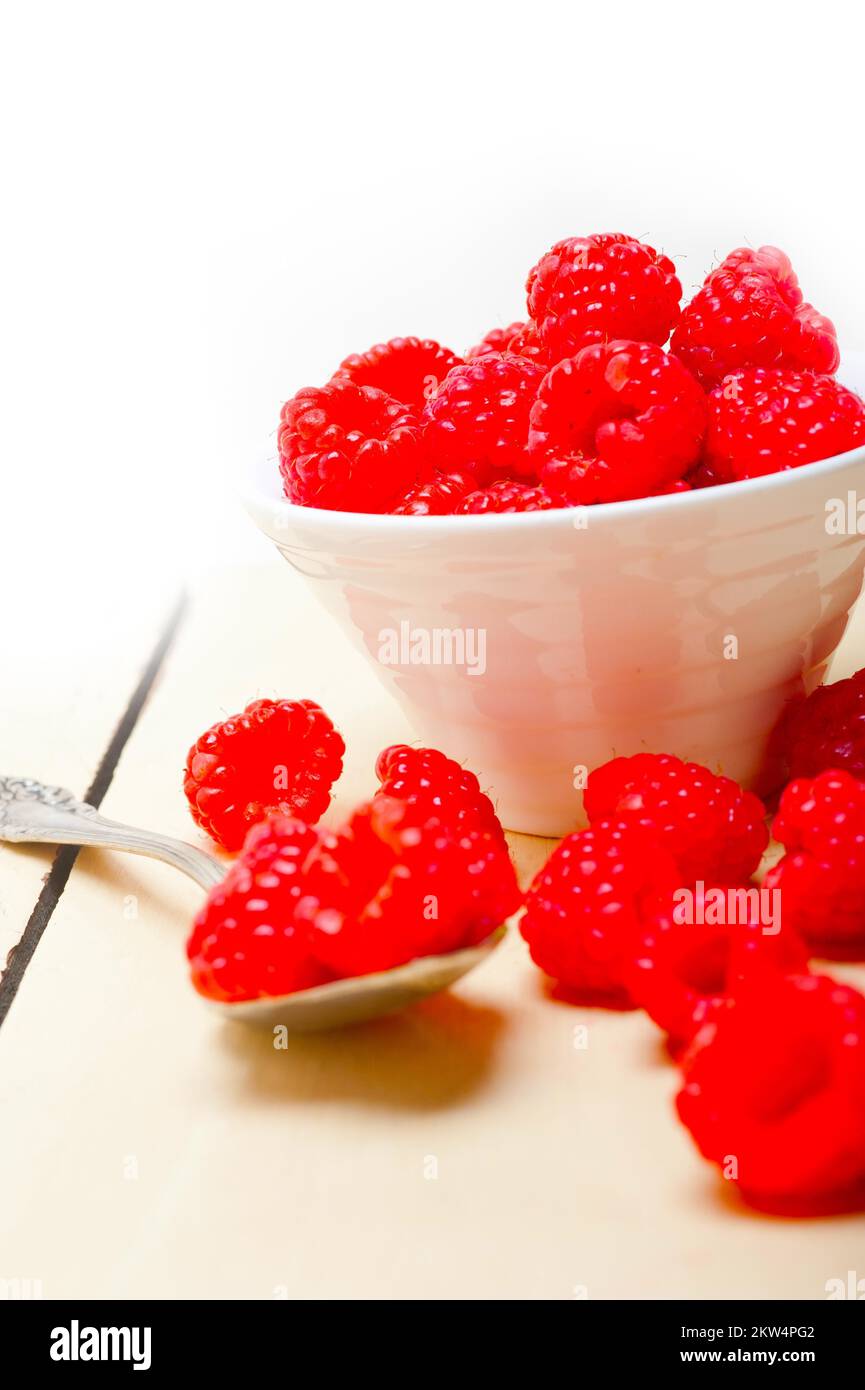 Bunch of fresh raspberry on a bowl and white wood rustic table Stock ...