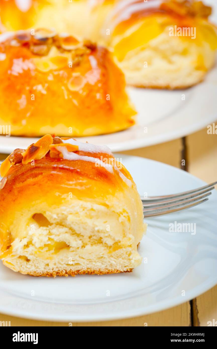 Fresh home baked sweet bread donut cake with almonds and icing sugar on ...