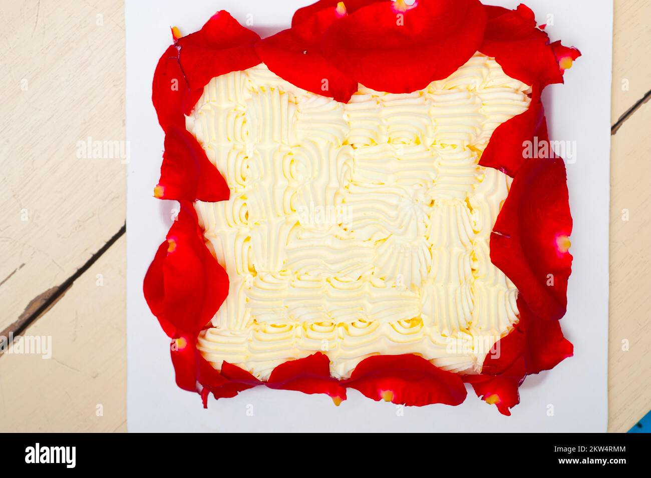Whipped cream mango cake with red rose petals Stock Photo - Alamy