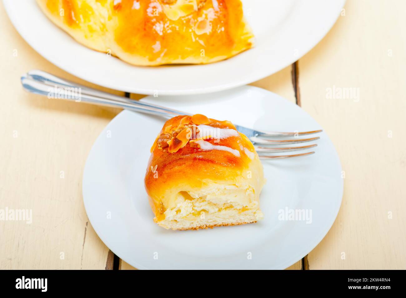 Fresh home baked sweet bread donut cake with almonds and icing sugar on ...