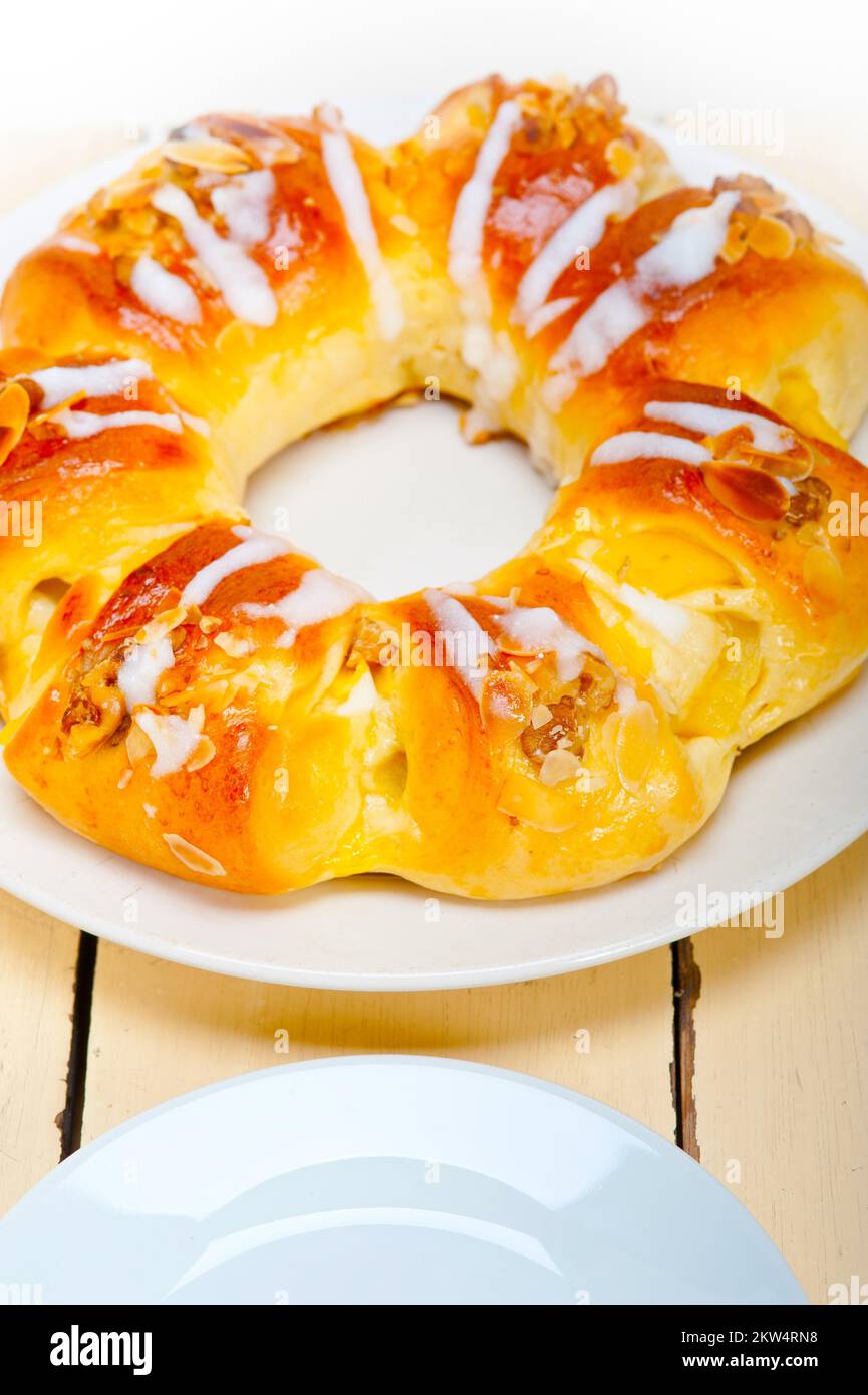 Fresh home baked sweet bread donut cake with almonds and icing sugar on ...