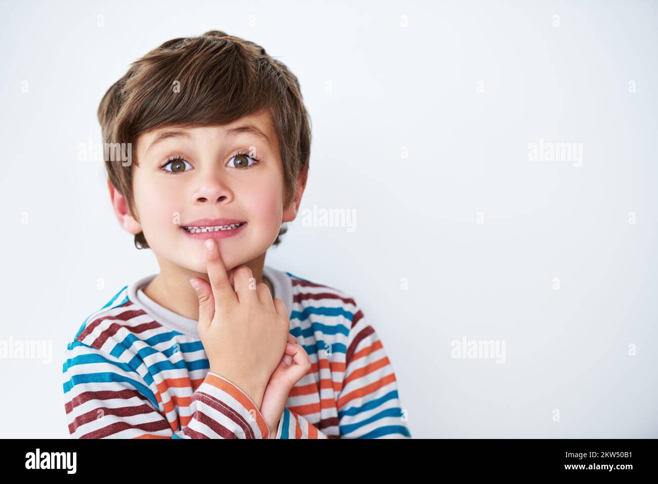Let me think about that...a cute little boy looking at the camera Stock ...