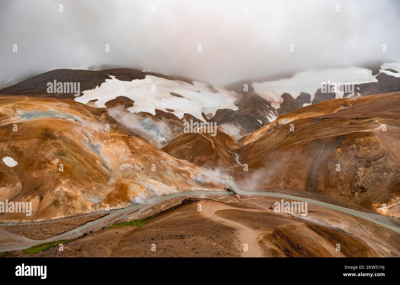 Bridge and steaming streams between colourful rhyolite mountains and ...