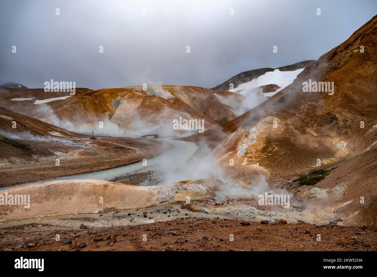 Bridge and steaming streams between colourful rhyolite mountains and ...