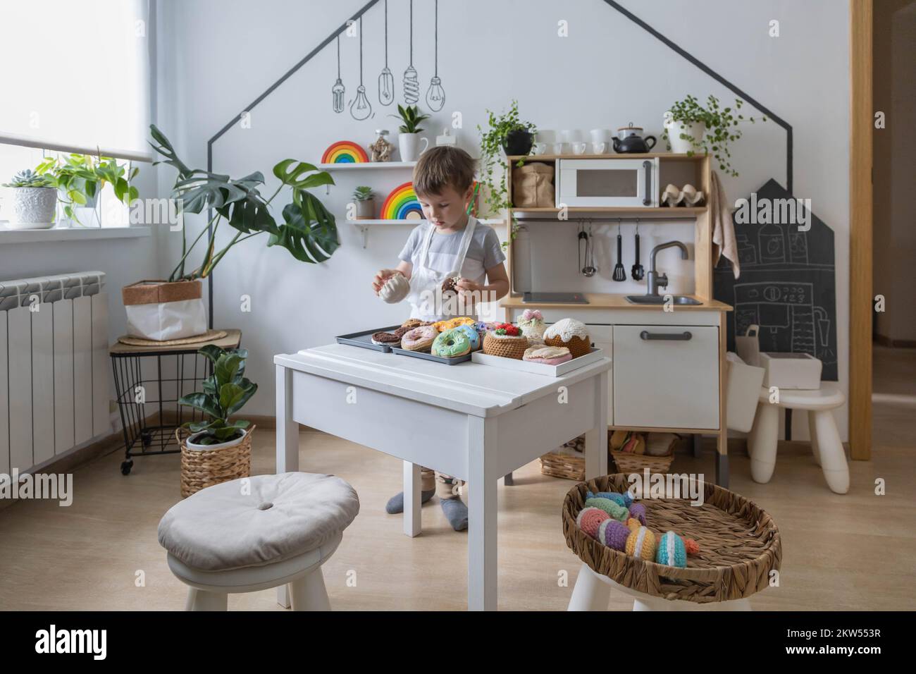 Portrait smiling male kid cafe chef posing with tray full sweet ...
