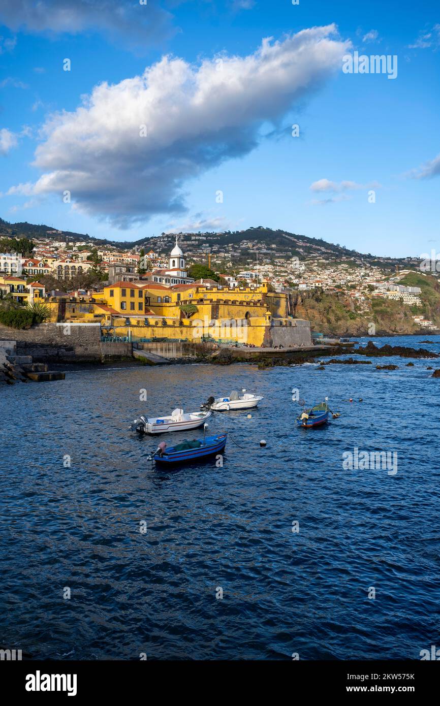 View of Forte de Sao Tiago fortress, small boats on the coast, Funchal ...
