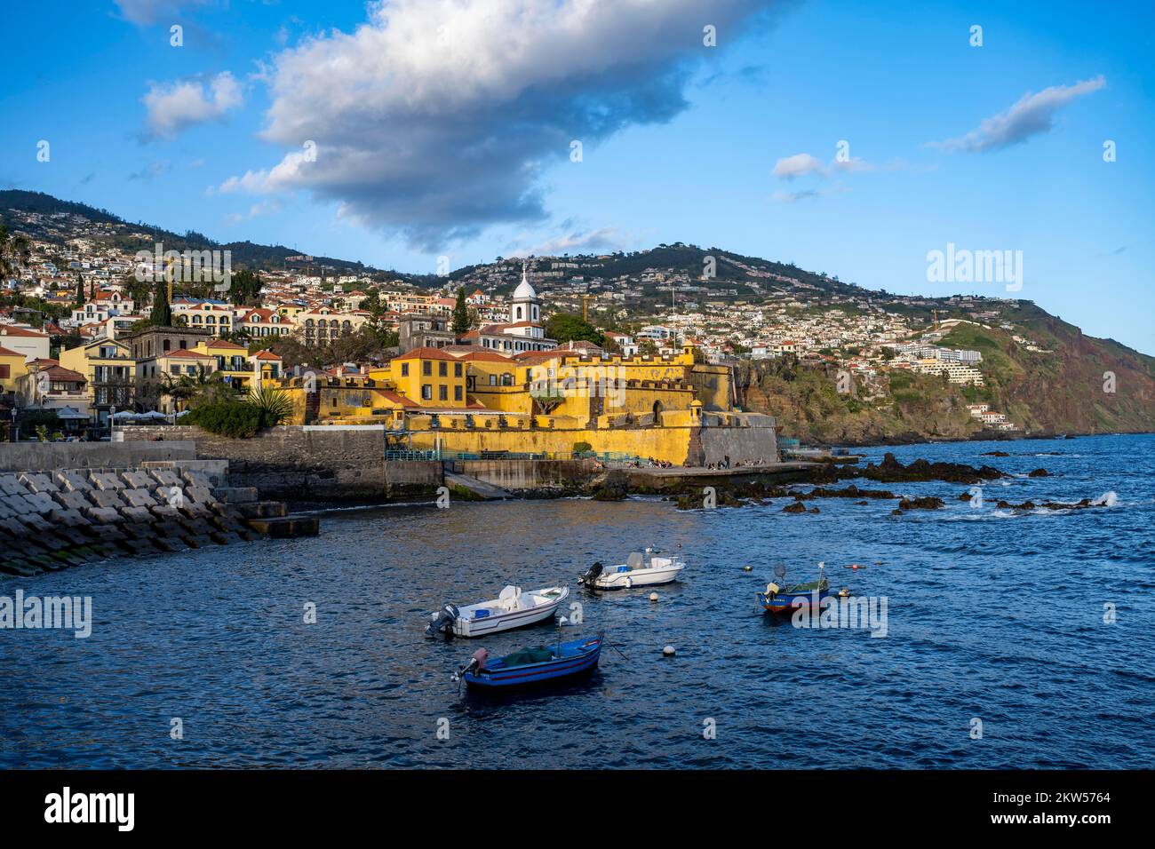 View of Forte de Sao Tiago fortress, small boats on the coast, Funchal ...