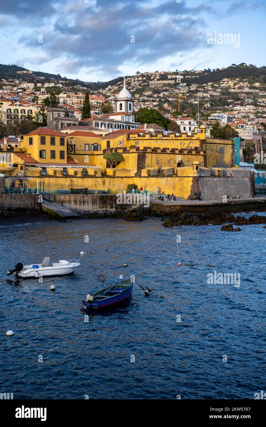 View of Forte de Sao Tiago fortress, small boats on the coast, Funchal ...
