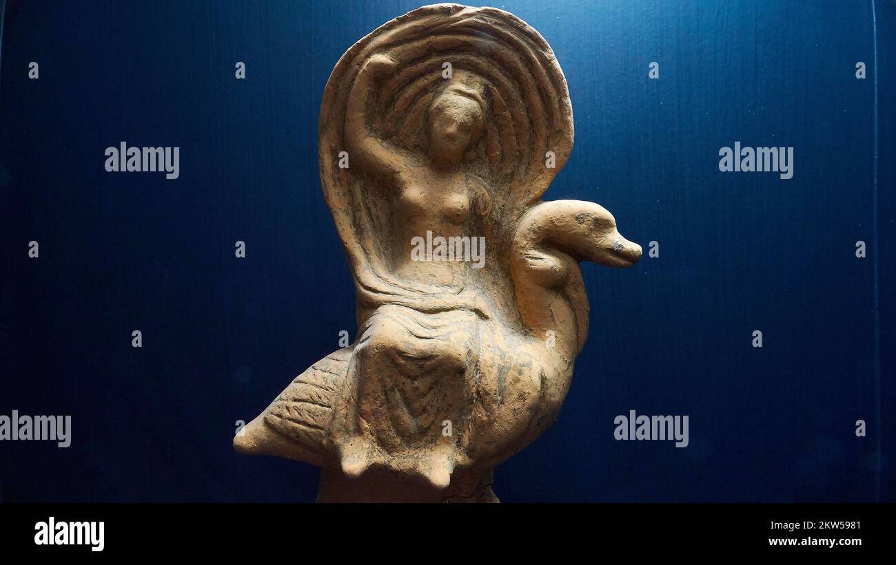 Terracotta figure, Leda and Zeus as swan, blue background ...
