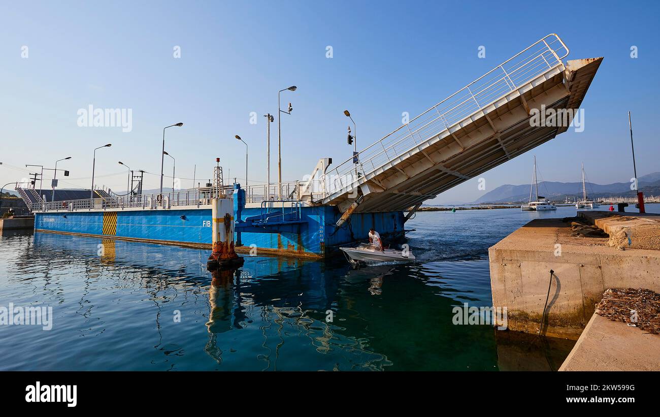 Half open swing bridge, Santa Maura ferry bridge, small motorboat under ...
