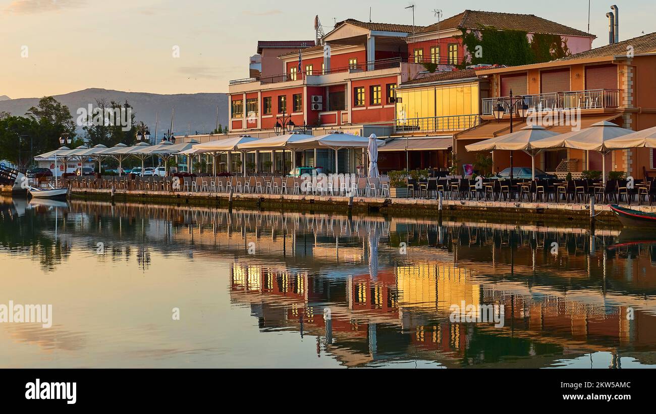 Morning light, houses on the waterfront, reflections in the water, sun ...