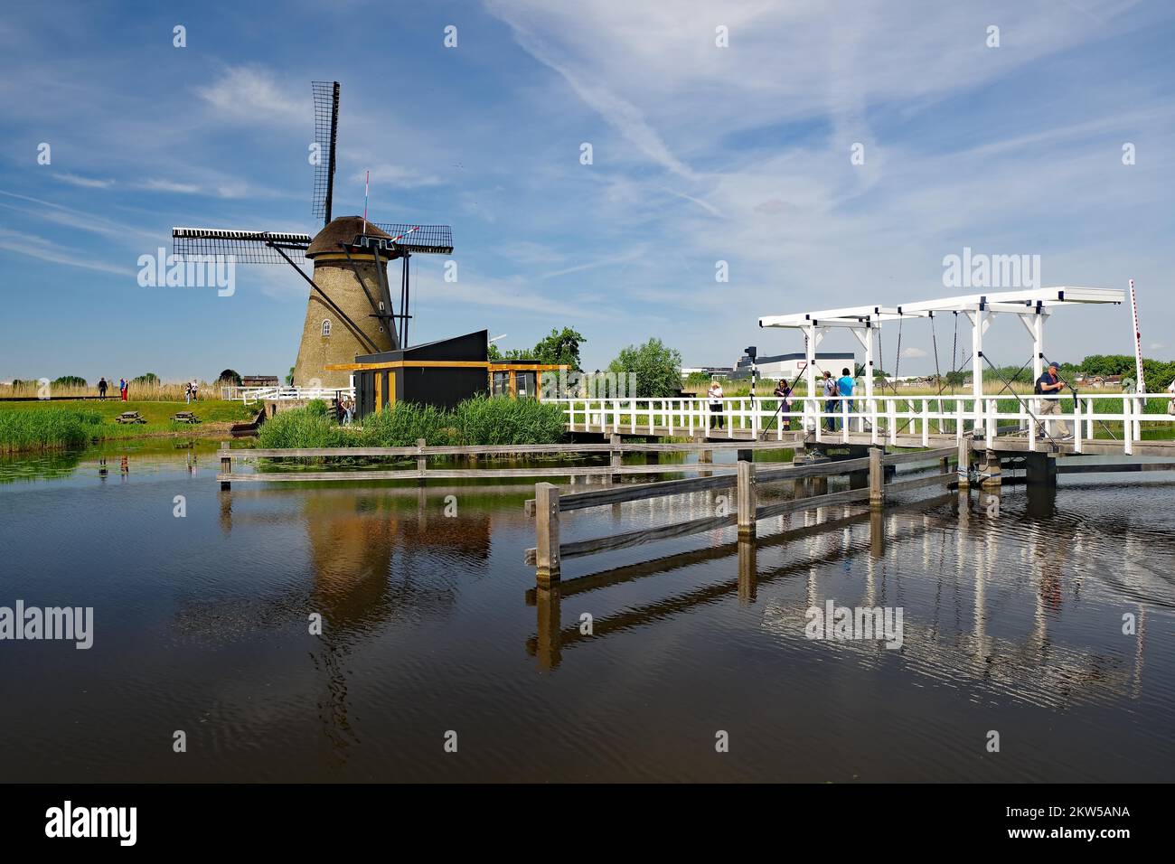 Old wooden windmill and bridge, quiet watercourse, Kinderdijk, Unesco ...