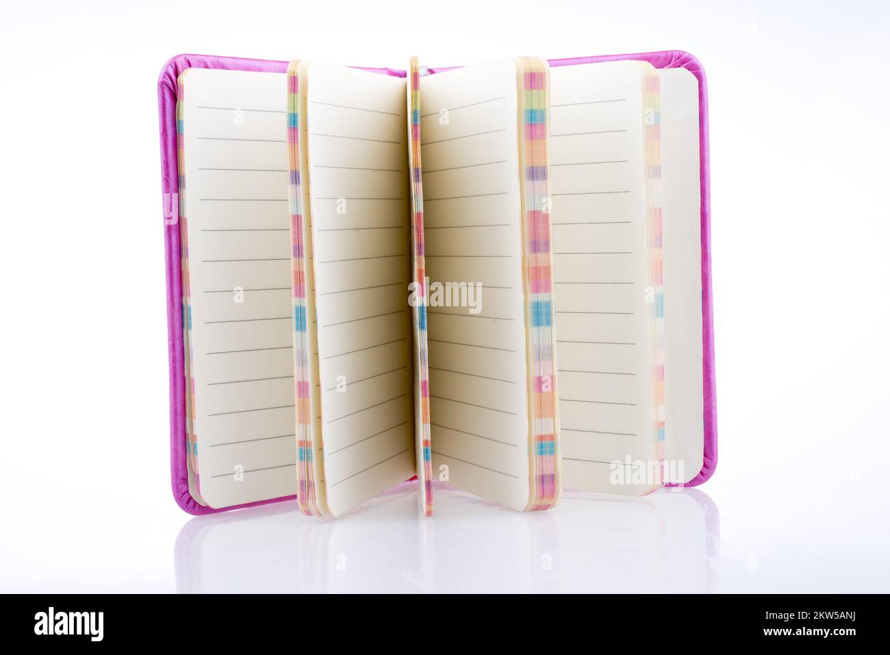 Pink notebook on a white background Stock Photo - Alamy