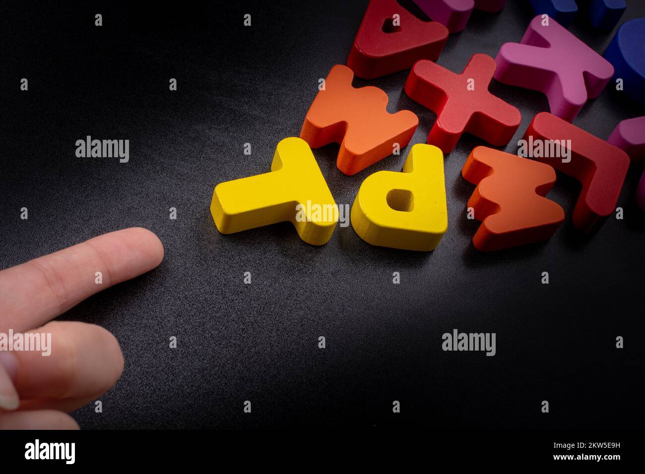 Fingers and Colorful Letters of Alphabet made of wood Stock Photo - Alamy