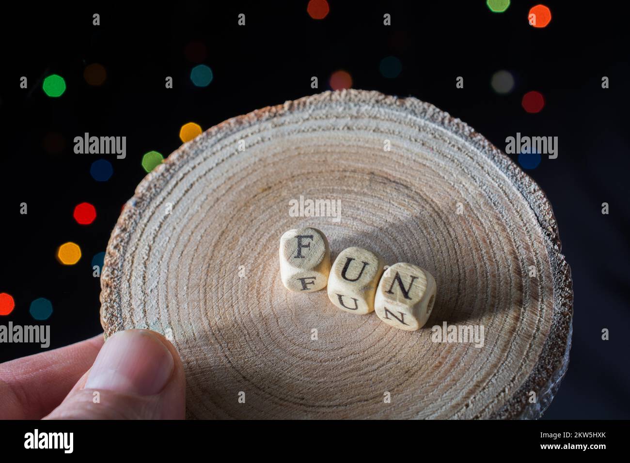 Fun wording in hand cubes bokeh lighton a dark background Stock Photo ...