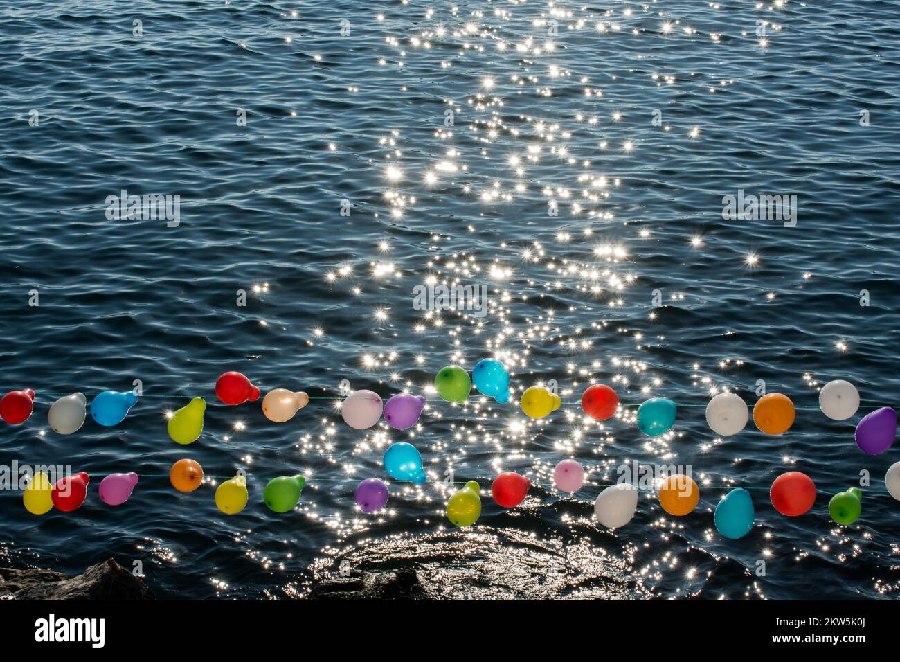 Balloon on a string on water for shooting game Stock Photo - Alamy