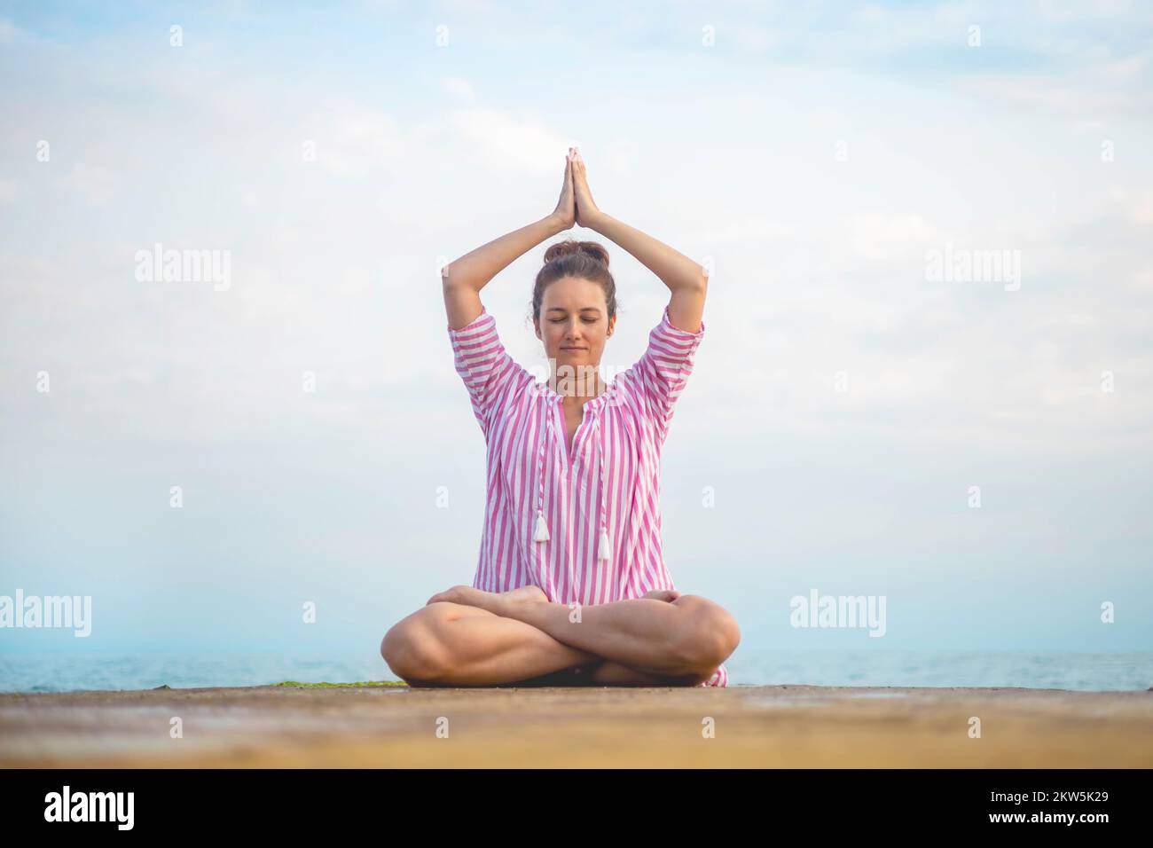Yoga woman meditation prayer hands namaste overhead lotus position ...
