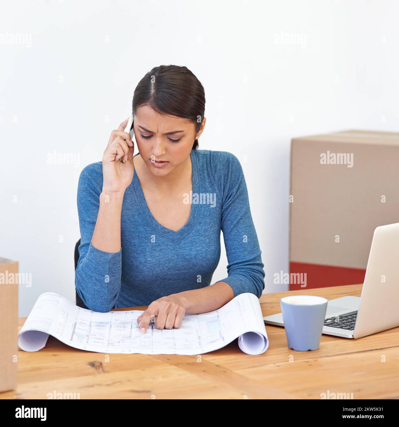 These plans are not up to spec. a young female entrepreneur talking on ...