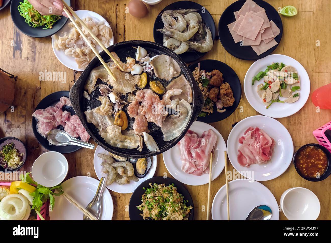 BBQ Barbecue eating. People grilling pork, meal, shellfish and shrimp ...