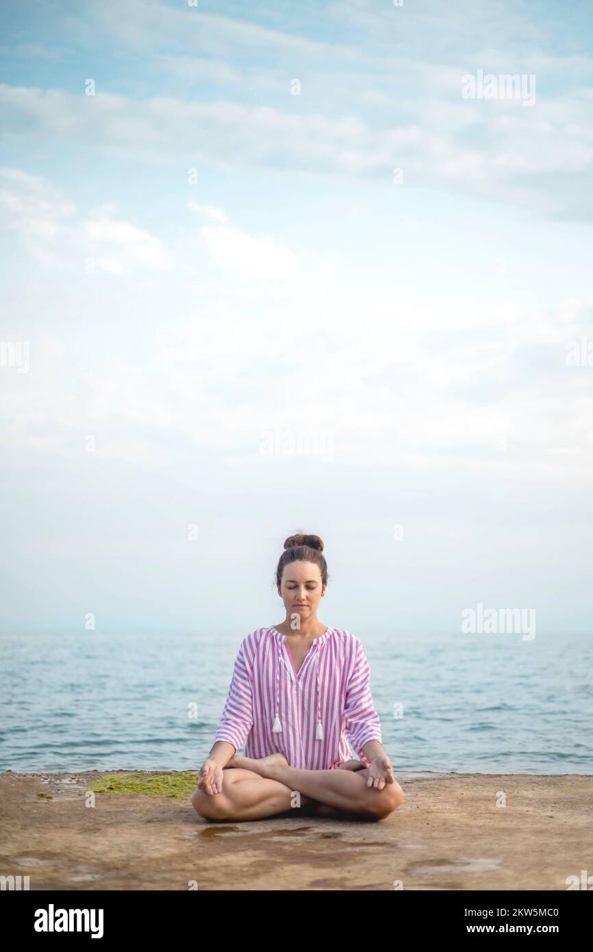 Yoga woman meditation prayer hands namaste overhead lotus position ...