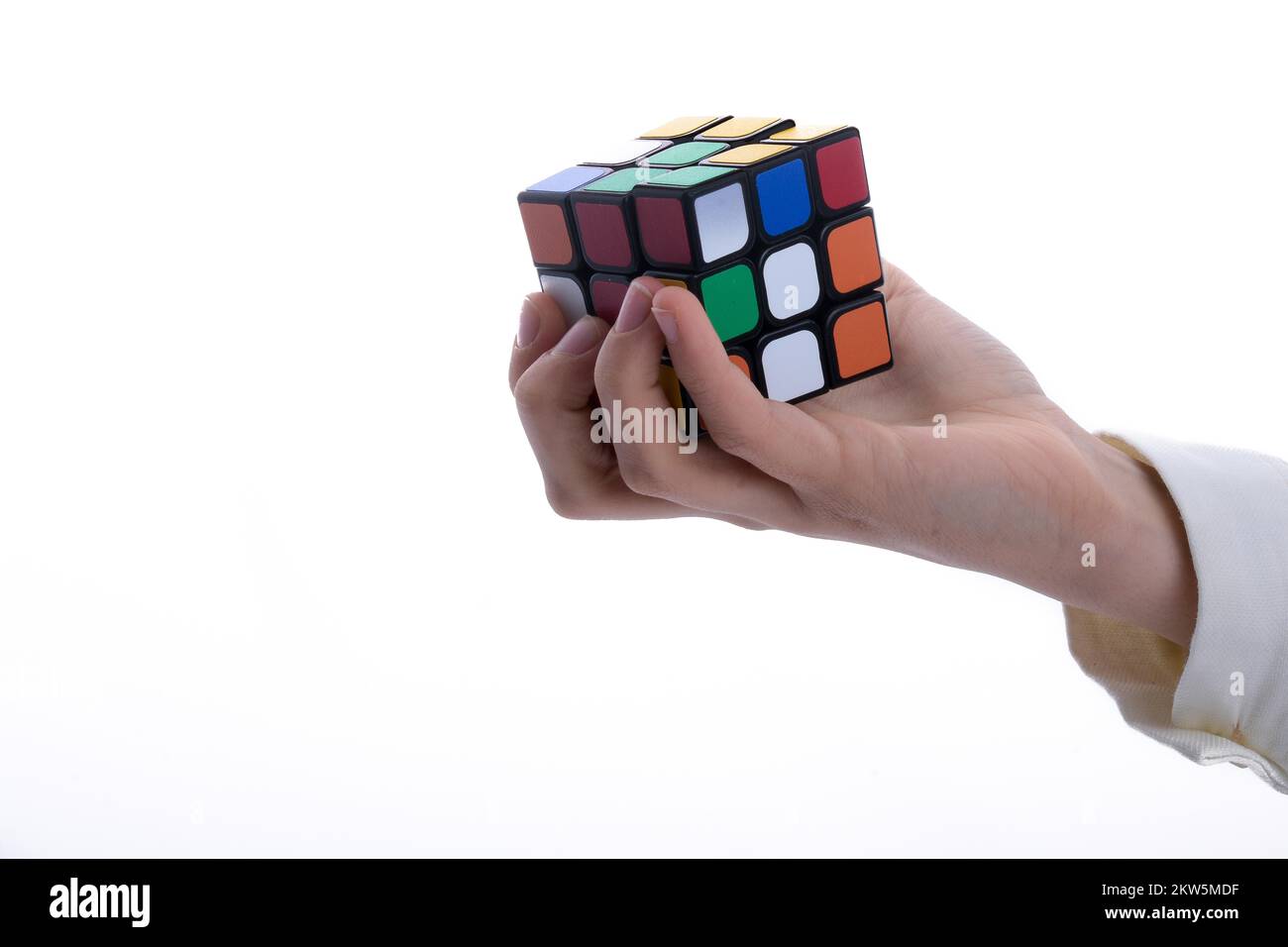 Child holding a Rubik's cube in hand on a white background Stock Photo ...