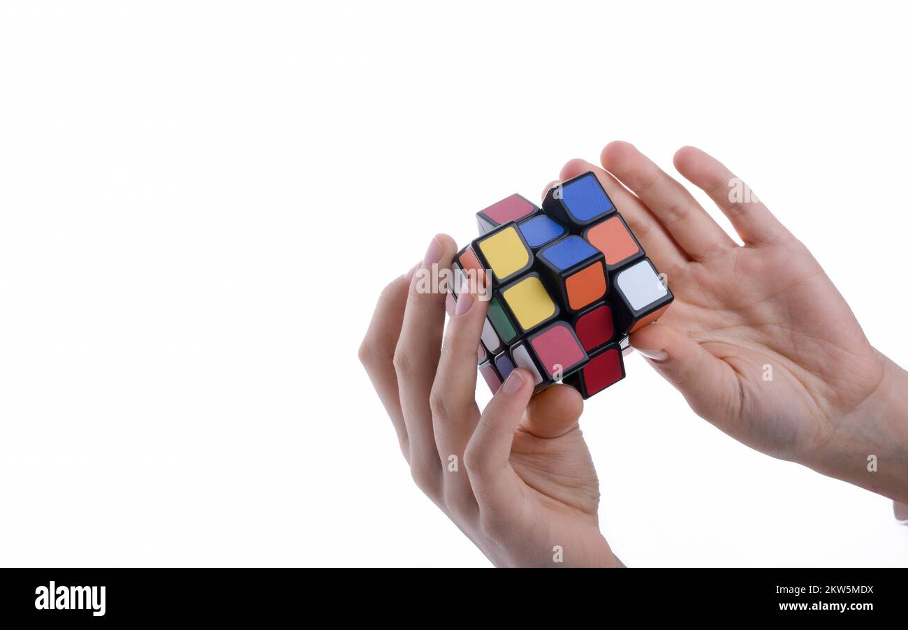 Child holding a Rubik's cube in hand on a white background Stock Photo ...