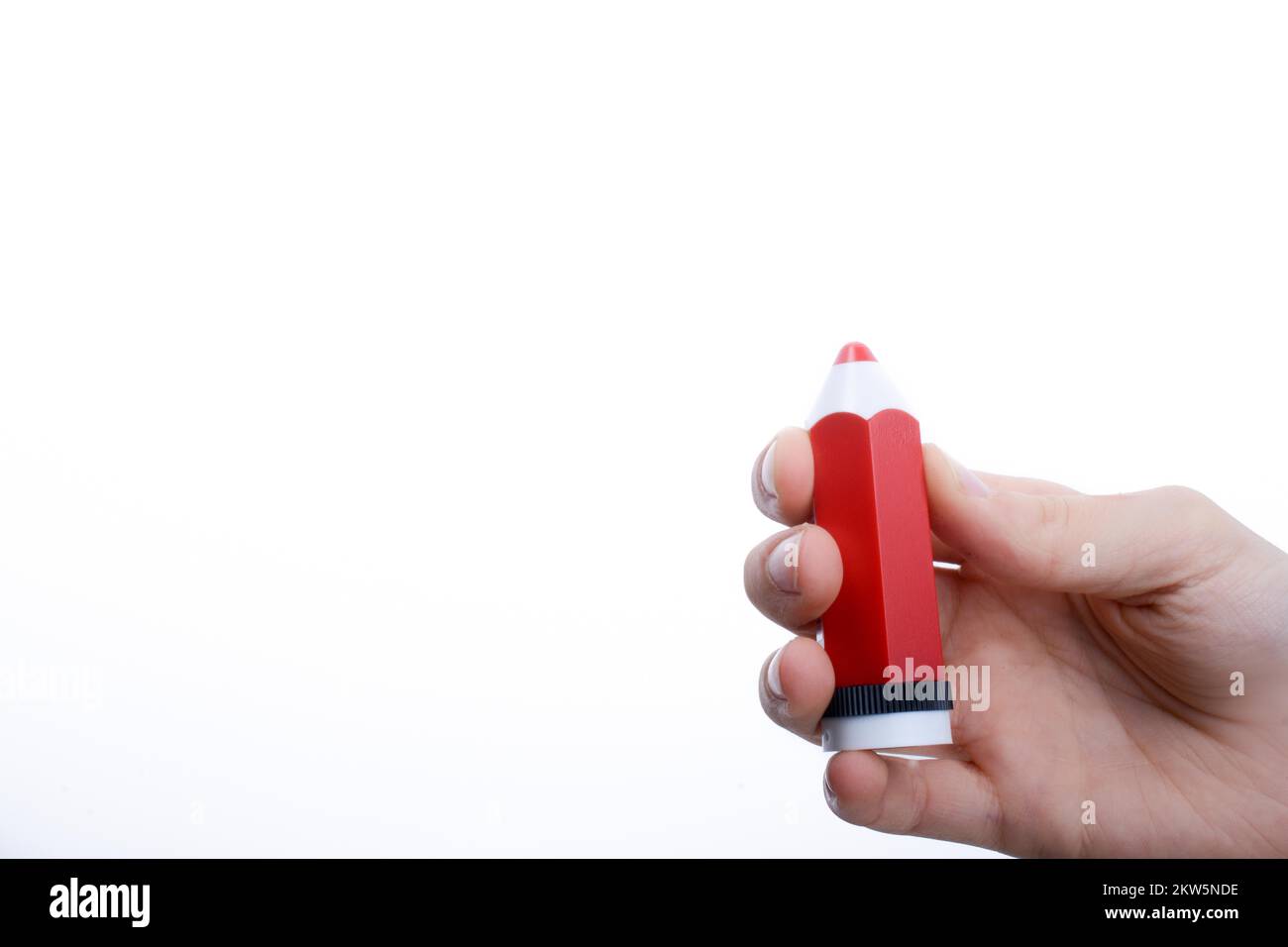 Isolated thick, red pencil in hand on a white background Stock Photo ...