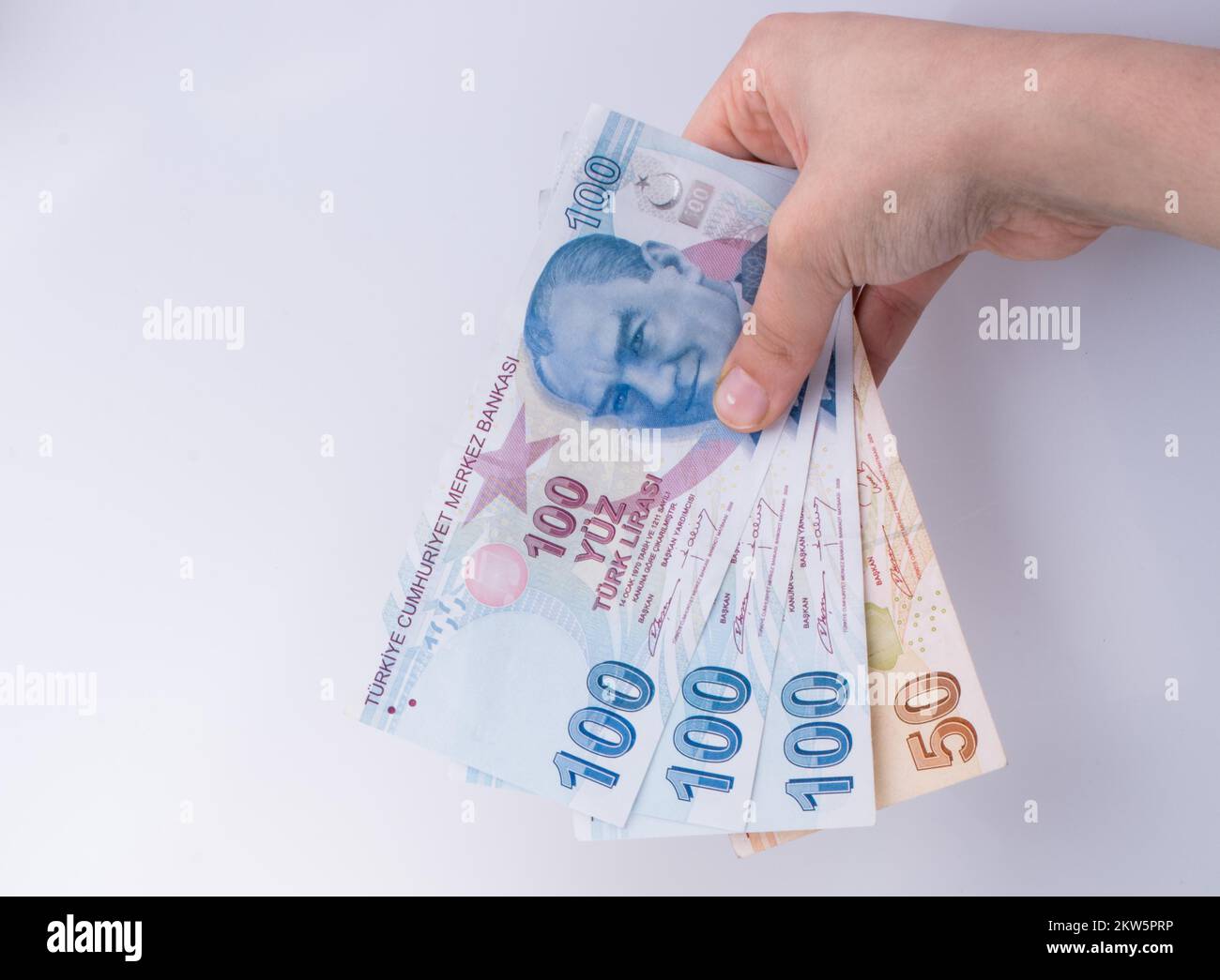 Hands holding American dollar banknotes and Turksh Lira banknotes side ...