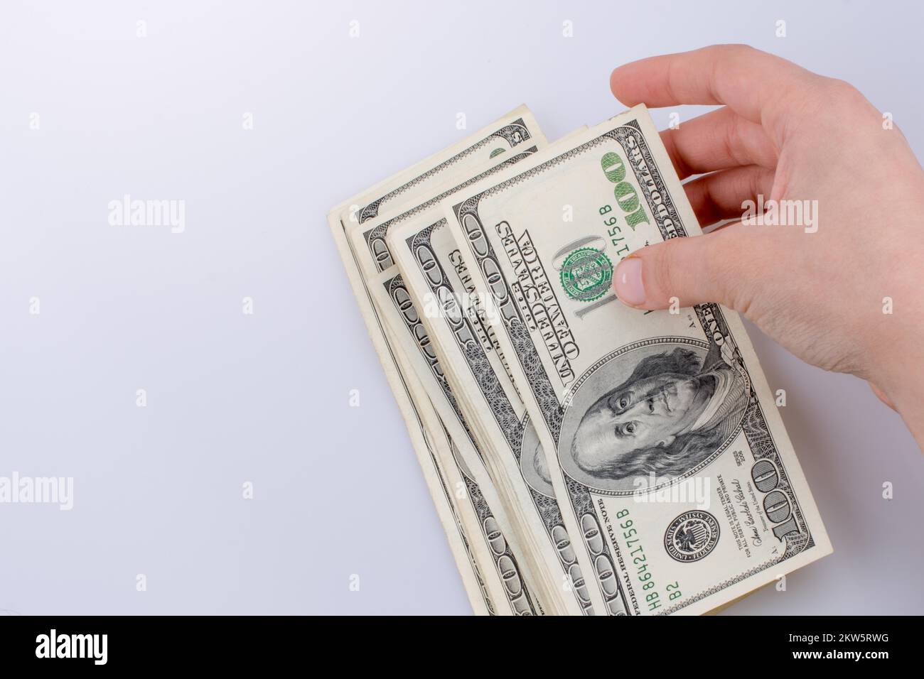 Human hand holding American dollar bill as money isolated on white ...