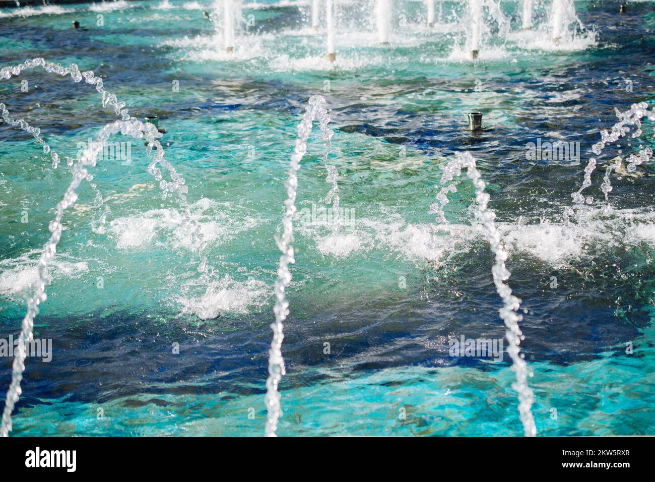 The fountains gushing sparkling water in a pool in a park Stock Photo ...