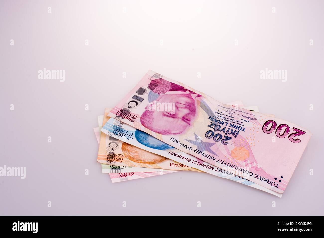 Turksh Lira banknotes of various color, pattern and value on white ...