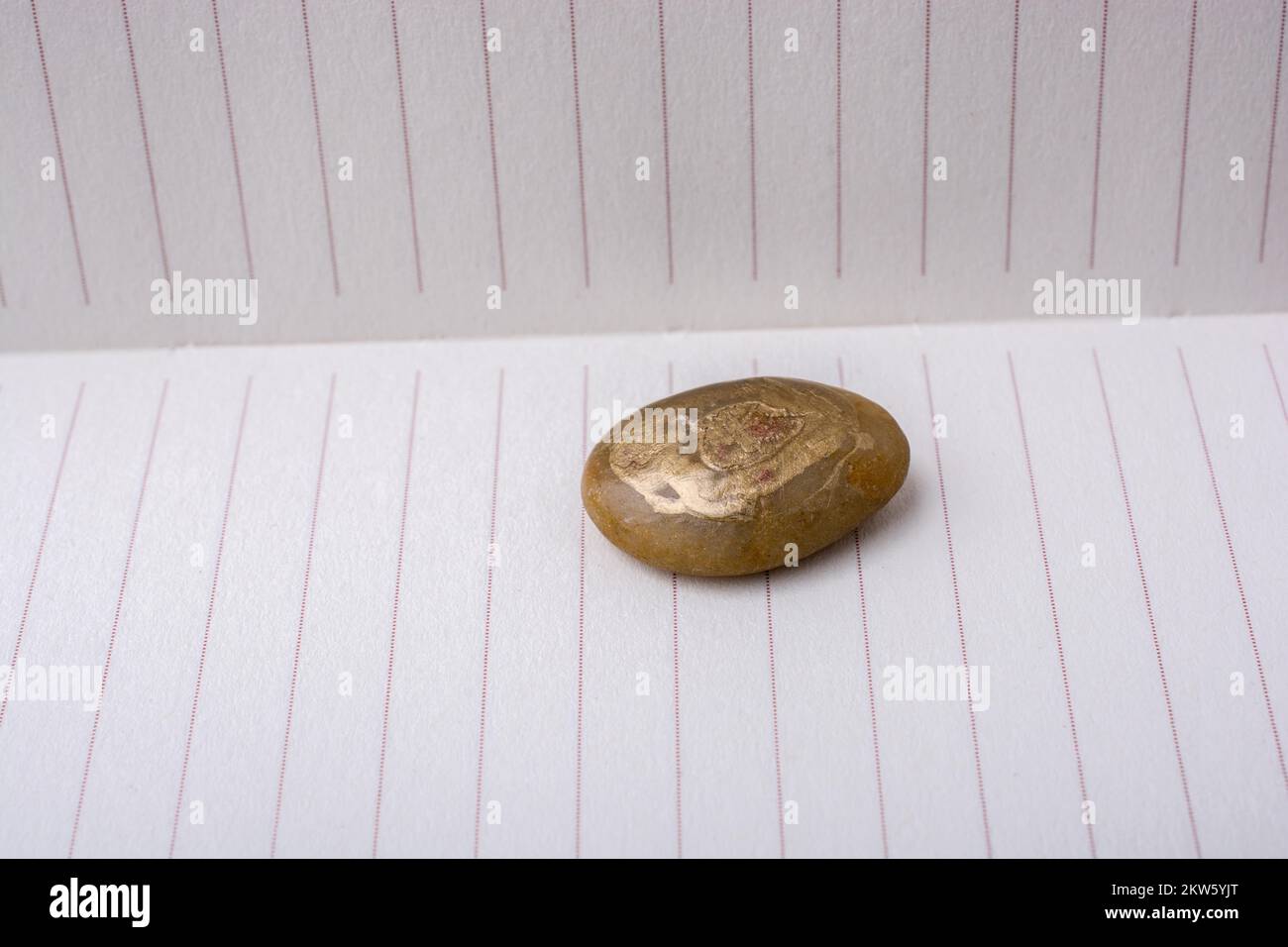 Little gold color stone on with a background Stock Photo - Alamy