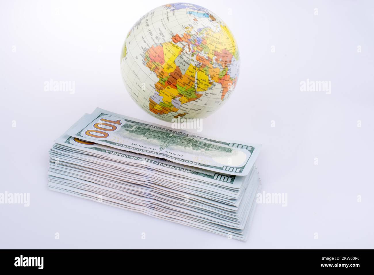 American dollar banknotes by the side of a model globe on white ...