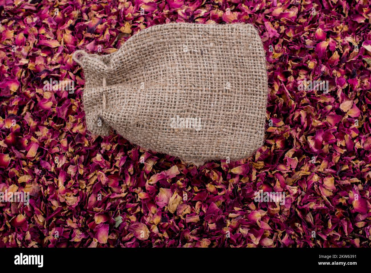 Linen sack placed on Background of dried rose petals Stock Photo - Alamy