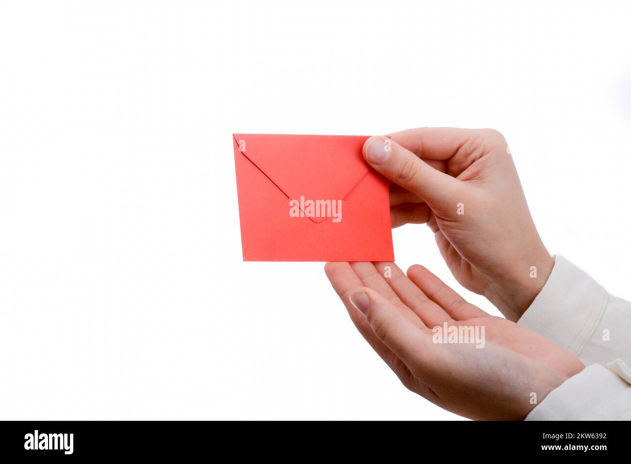 Hand holding a red envelope on a white background Stock Photo - Alamy
