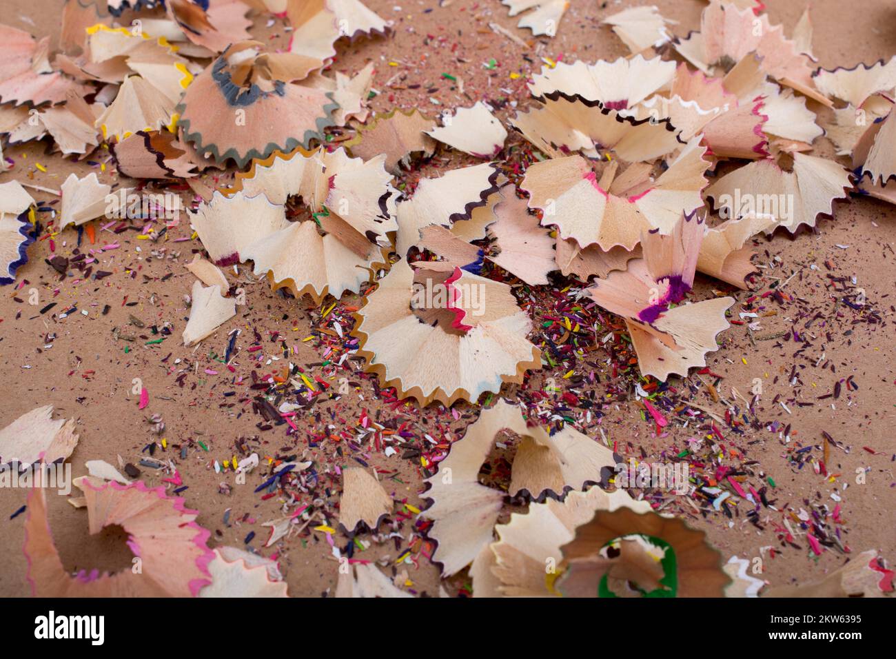 Colorful pencil shavings on a brown background Stock Photo - Alamy