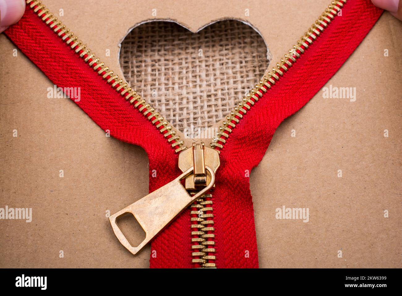 Zipper and heart shape hole on paper Stock Photo - Alamy