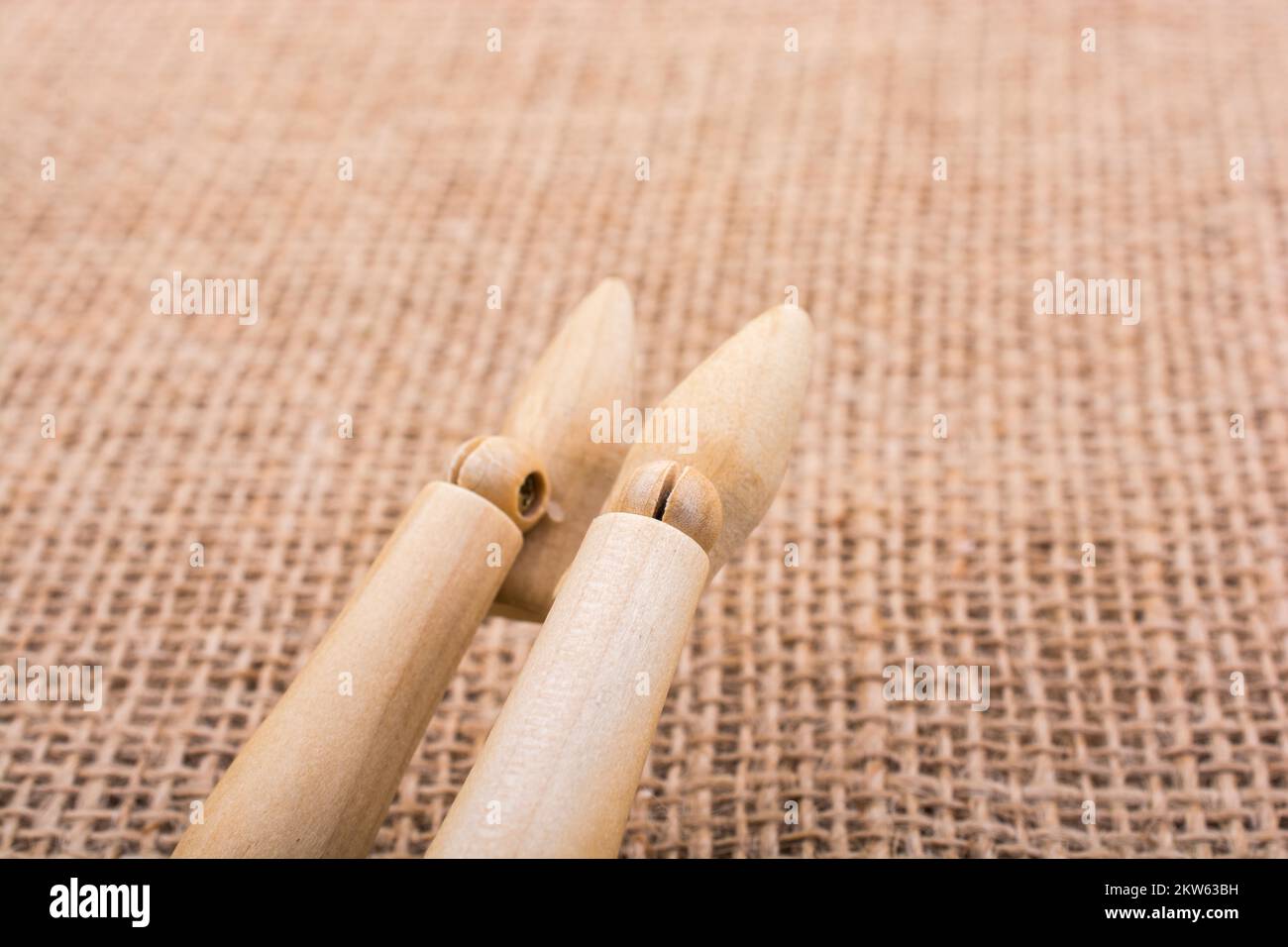 Wooden dolls posing with his legs on canvas Stock Photo - Alamy