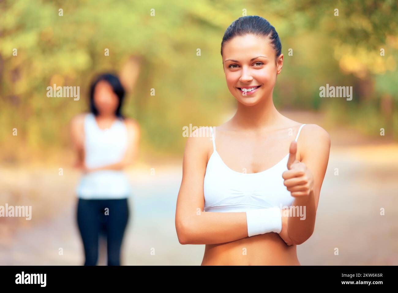 Feeling awesome and healthy. two young women in exercise clothing standing outside giving the ...