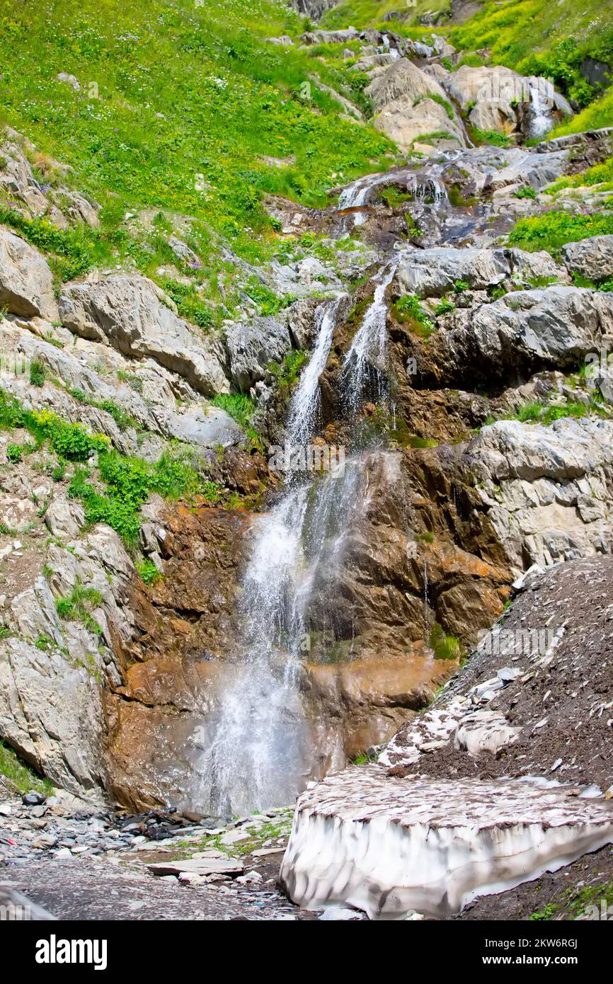 Beautiful waterfall in the mountains. Water flows down from the ...
