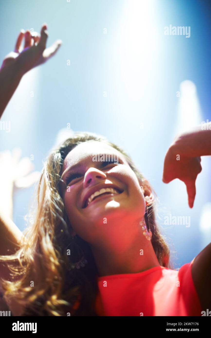 Feeling the vibe. Cropped view of a young woman dancing in a club Stock ...