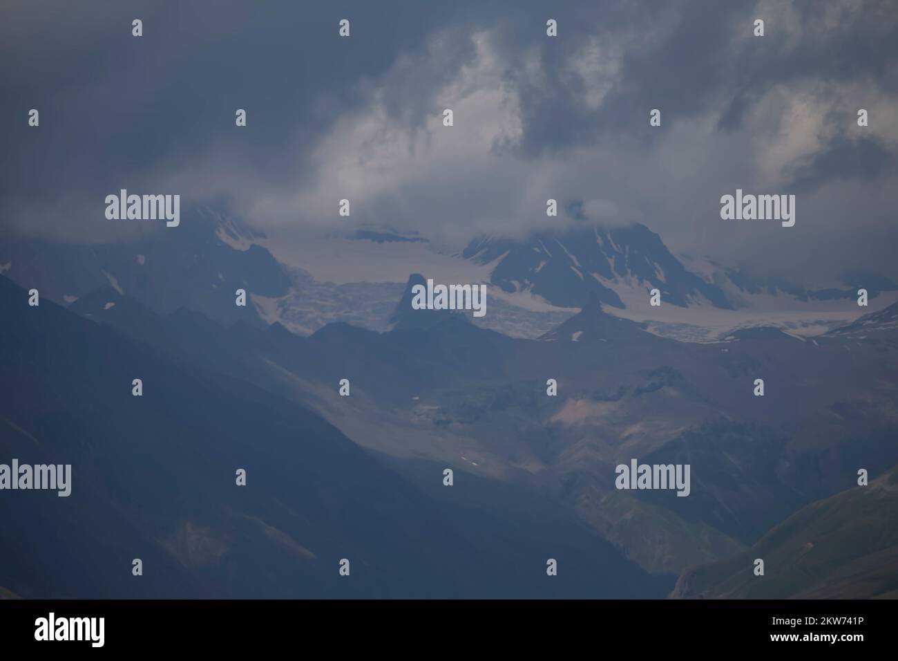 Dark atmospheric surreal landscape with a dark rocky mountain peak in ...