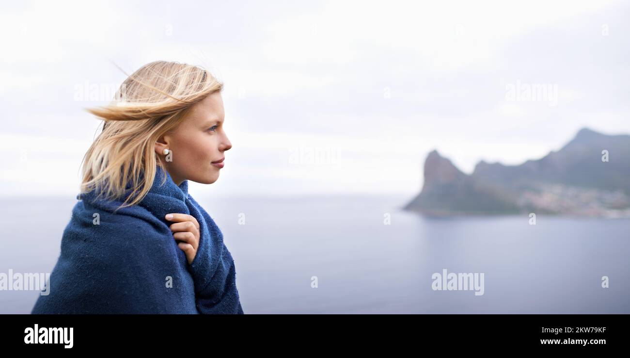 Morning contemplation. a beautiful young woman standing at the ocean ...