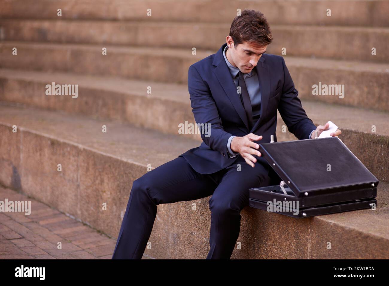 Ready to win his case. a businessman looking into his briefcase while ...