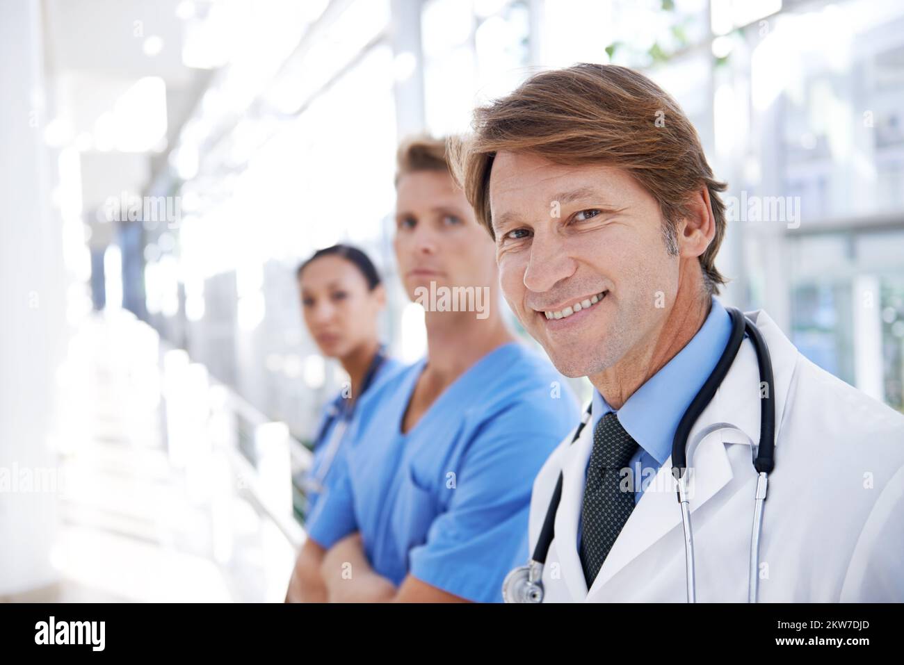 Teamwork and medicine. A medical team standing in the hospital corridor ...