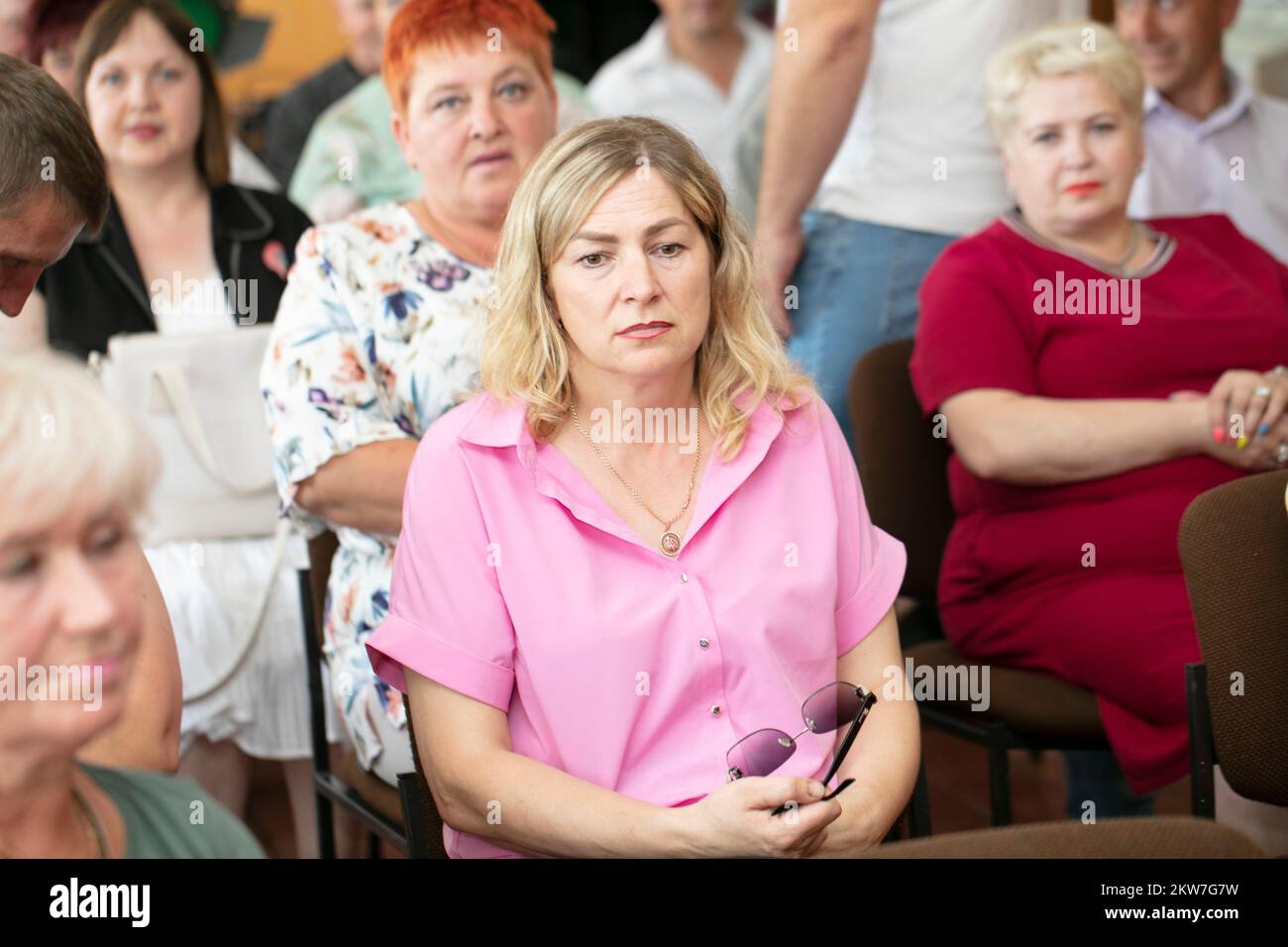 Meeting for the people.Woman spectator is sad, bored Stock Photo - Alamy