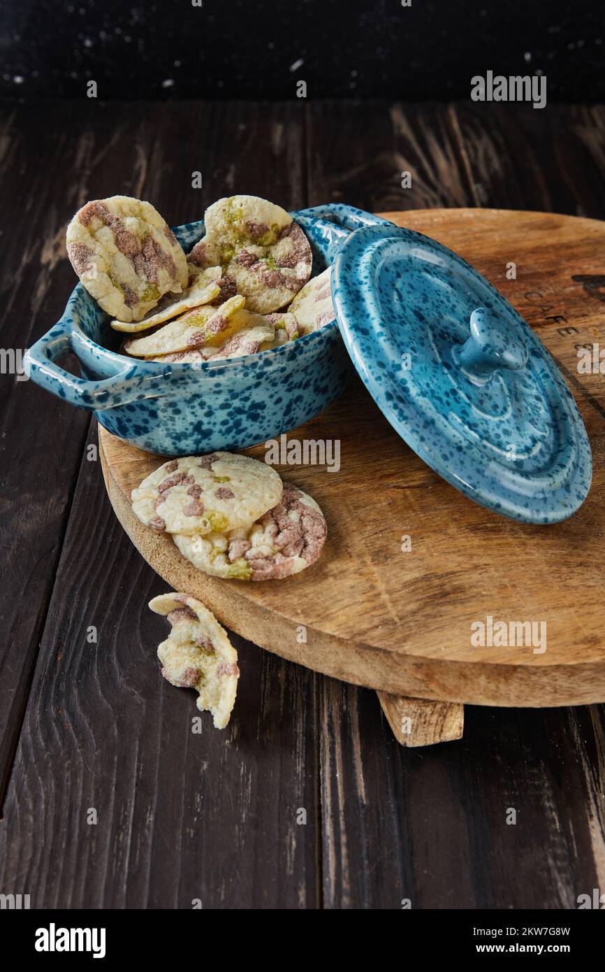 Puff chips with chickpeas, peas and beans in glass bowl with lid on ...