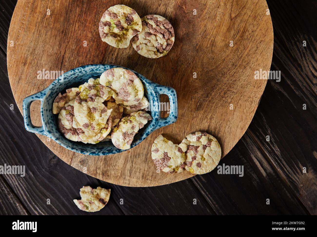 Puff chips with chickpeas, peas and beans in bowl on wooden background ...